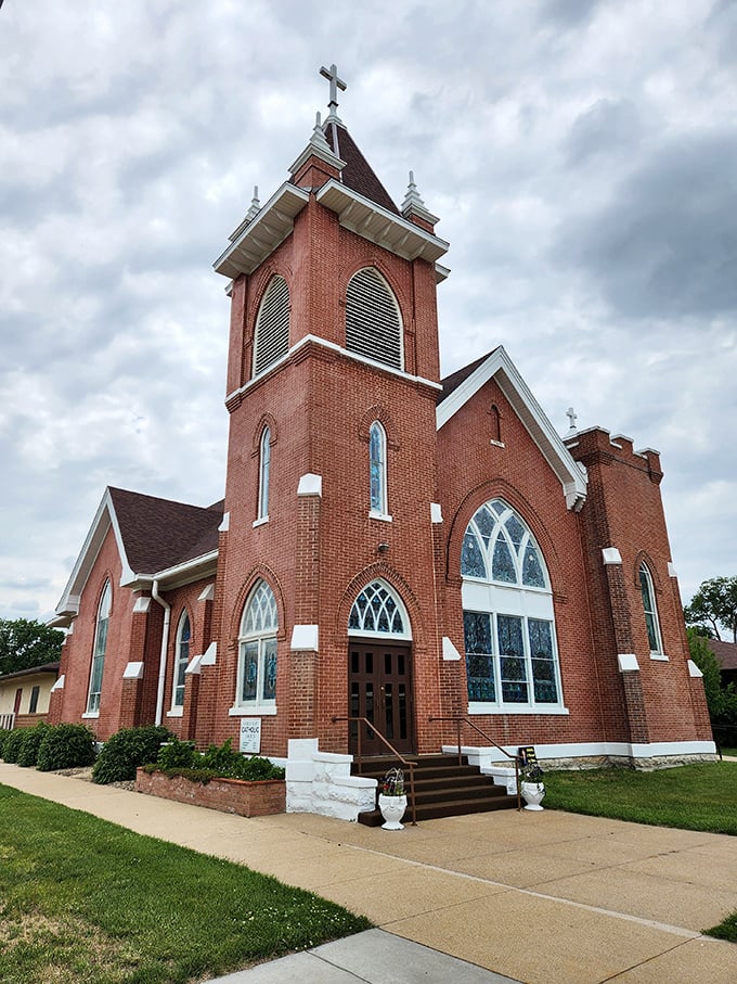 Sacred Heart Catholic Church's red brick tower reaches skyward, its Gothic windows and detailed masonry a testament to the faith and craftsmanship of early settlers.