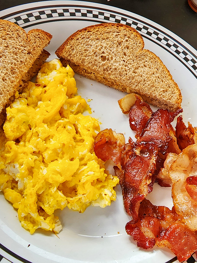 Breakfast perfection on a plate. Those scrambled eggs look fluffier than the pillows at a five-star hotel. 