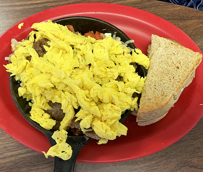 Fluffy scrambled eggs nestled in a skillet, proving that sometimes the simplest pleasures are the most satisfying ones.