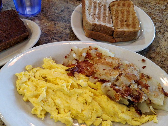 Scrambled eggs that actually look like someone cared, paired with home fries that achieve that perfect crisp-tender balance. Breakfast nirvana exists!