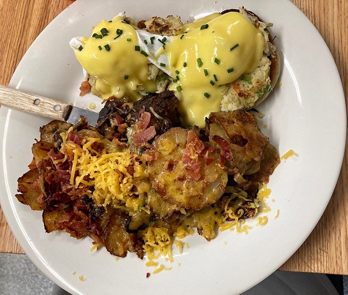 The Seafood Cake Benedict elevates breakfast to coastal luxury&mdash;golden crab cakes crowned with poached eggs and sunshine-yellow hollandaise sauce.