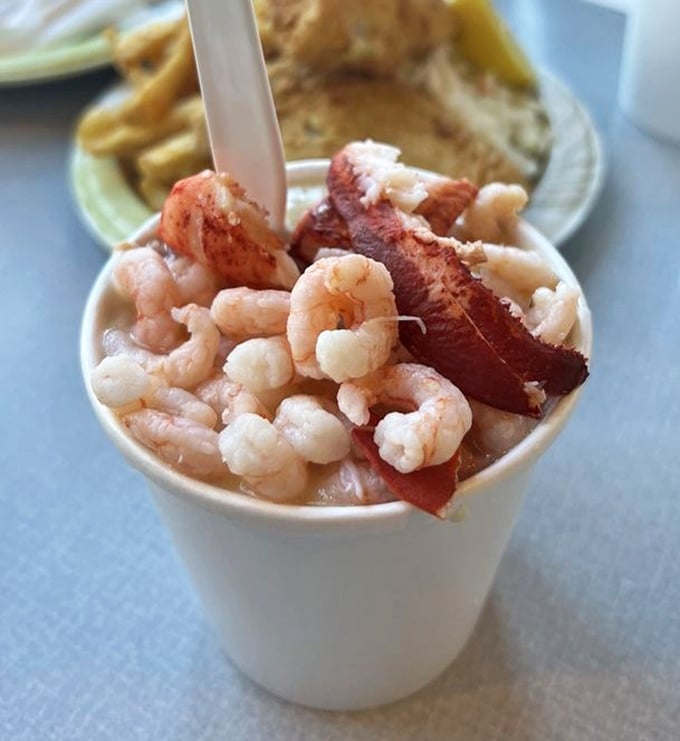 Ocean in a cup! This seafood chowder packs more treasures than a pirate's chest—tender shrimp and what appears to be bacon adding a smoky surprise.