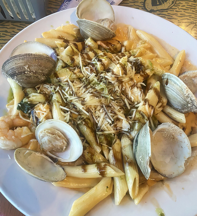 Pasta playing matchmaker between land and sea. Those clams are practically waving hello from their al dente neighborhood.