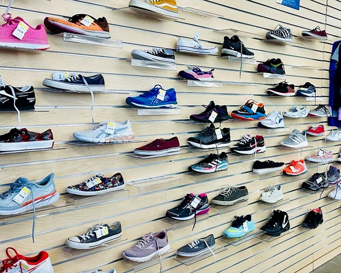 A wall of sneakers displayed like art in a gallery, each pair waiting for its Cinderella moment.