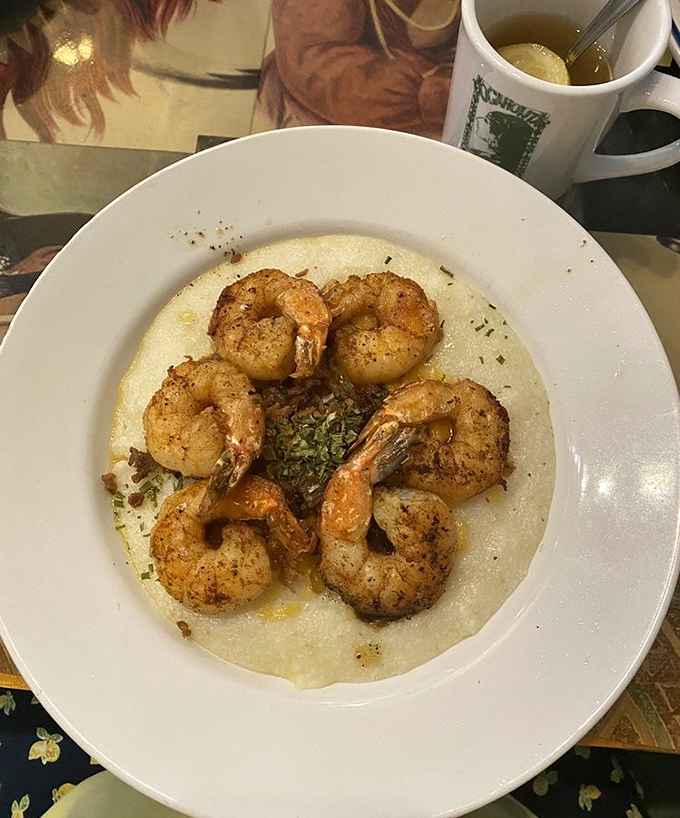 Shrimp and grits elevate breakfast from mere sustenance to culinary event, with perfectly seasoned crustaceans dancing atop a creamy cornmeal stage.