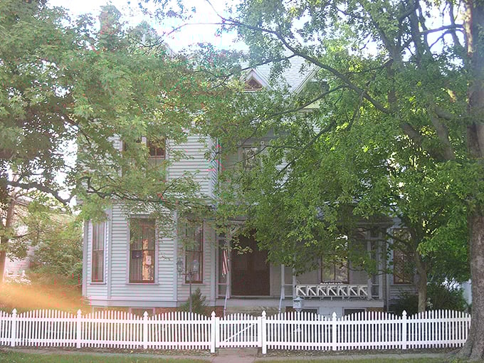 The white picket fence isn't just for show &ndash; it's practically the town motto in architectural form, framing this classic American home like a living history exhibit.