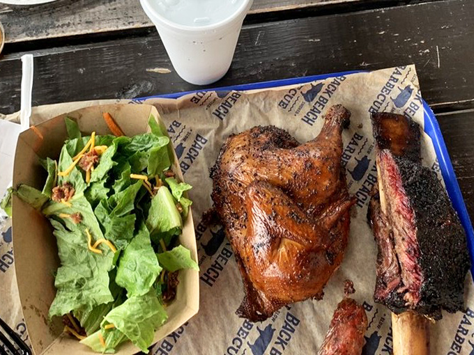 A barbecue trifecta: smoke-kissed chicken, perfectly charred brisket, and a side salad pretending it's the healthy choice. Spoiler alert: you'll devour it all.
