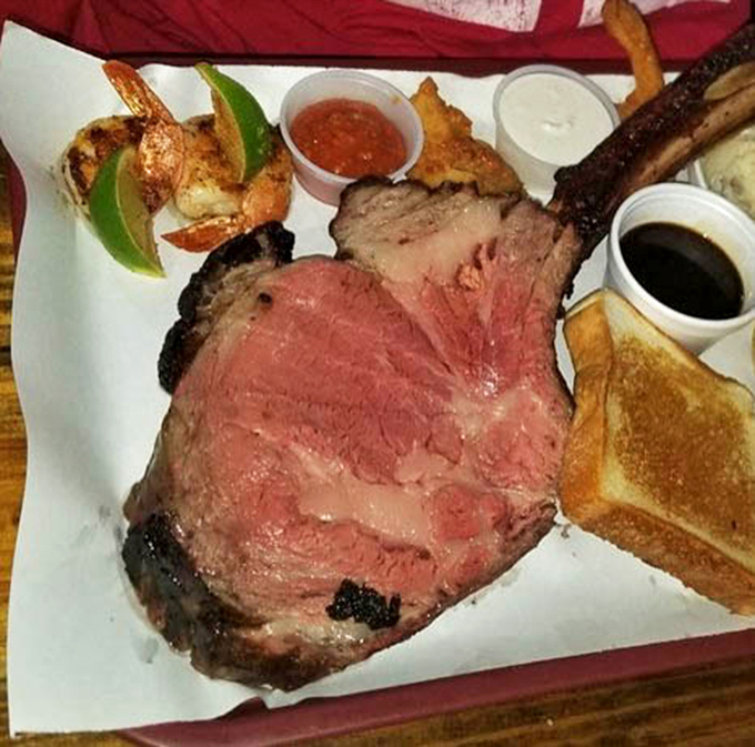 A smoked ribeye with shrimp that looks like it graduated summa cum laude from barbecue university with honors.