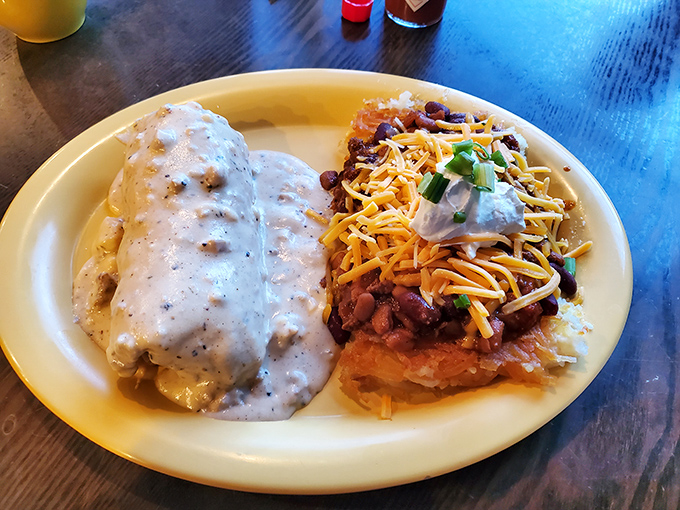 A hearty breakfast plate featuring The Chef's famous smothered burrito alongside a Southwestern-inspired dish topped with beans and cheese.