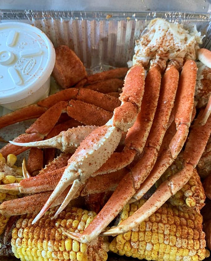 Seafood royalty has arrived: snow crab legs lounging on a bed of corn, seasoned to perfection and ready for their butter bath.