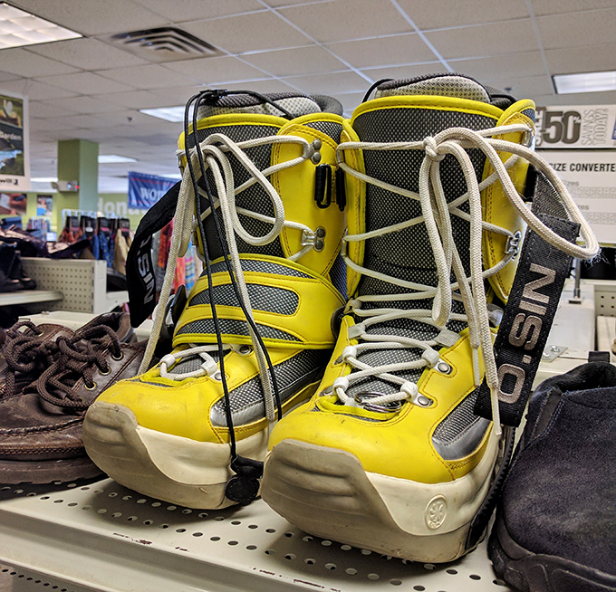 Bright yellow snowboard boots that scream "I make questionable color choices but excellent powder decisions!" Vermont winter gear at its most vibrant.