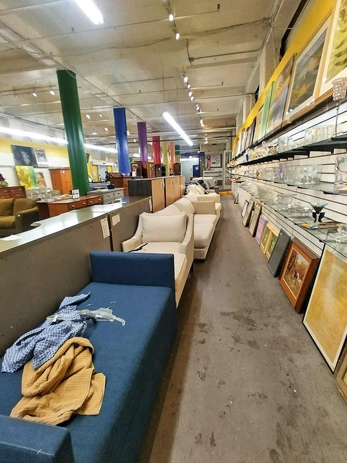 A gallery of seating possibilities lines this aisle, where cream-colored couches mingle with artwork like guests at an eclectic dinner party.