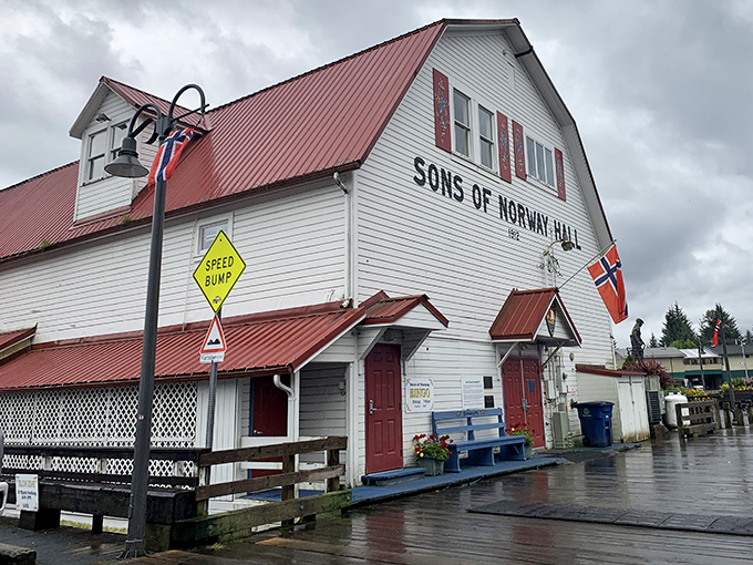 The Sons of Norway Hall stands proudly with its red roof and Norwegian flags &ndash; cultural heritage in architectural form.