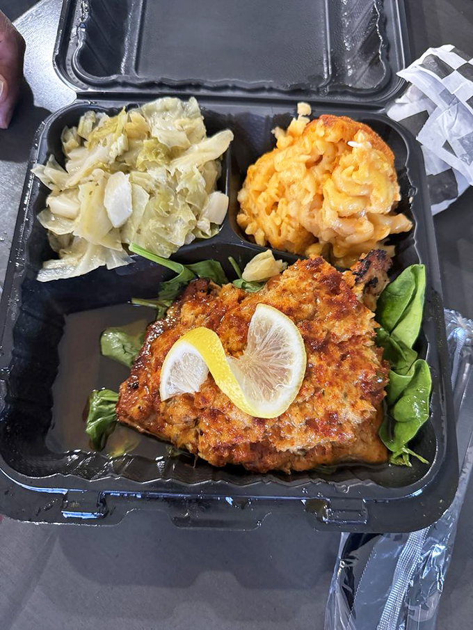 A perfectly seared fish filet rests on a bed of greens with lemon slices standing guard&mdash;proof that seafood deserves equal billing in soul food's greatest hits.