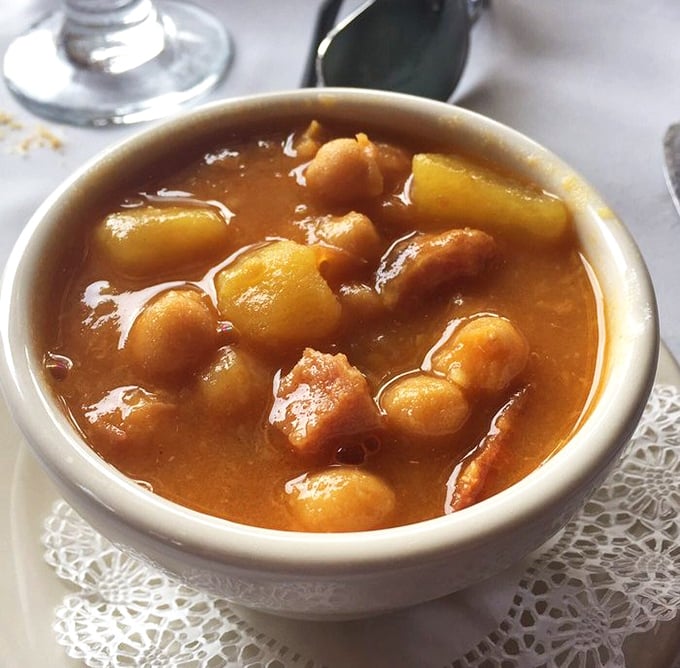 This Spanish bean soup isn't just comfort food&mdash;it's a warm hug in a bowl. Chickpeas and potatoes swimming in a broth that's been perfected over generations.