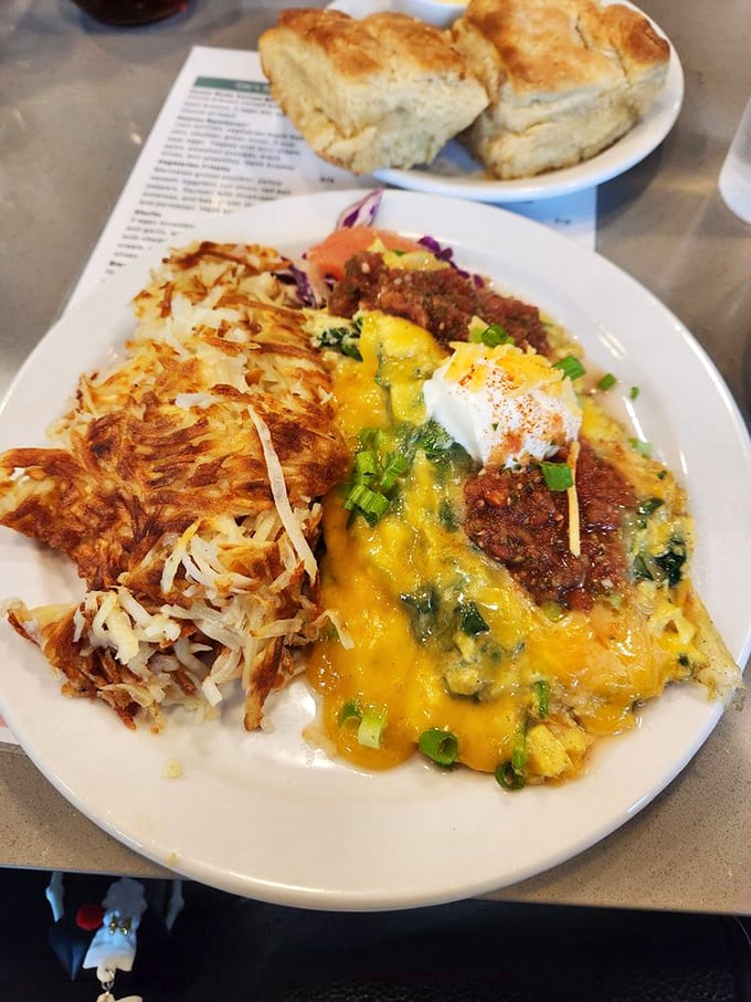 This isn't just an omelet&mdash;it's a flavor fiesta. Melted cheese blankets a medley of ingredients while those crispy hash browns wait patiently for their moment.