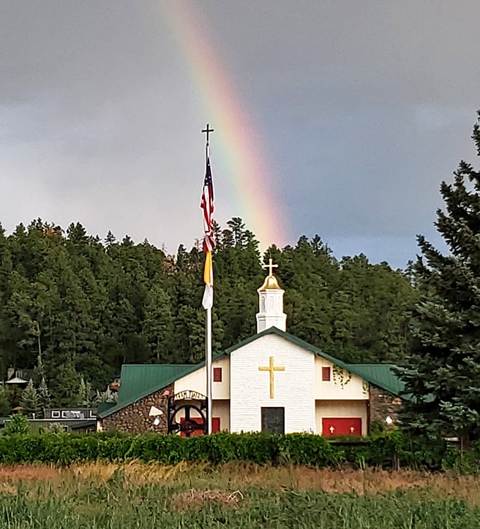 St. Rita's Catholic Church stands beneath a perfect rainbow&mdash;nature's way of confirming you made the right choice moving to Show Low's affordable paradise.