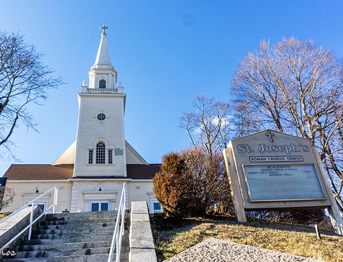 St. Joseph's Church rises above the neighborhood, its white steeple a beacon of both spiritual comfort and architectural grace in this working-class community.
