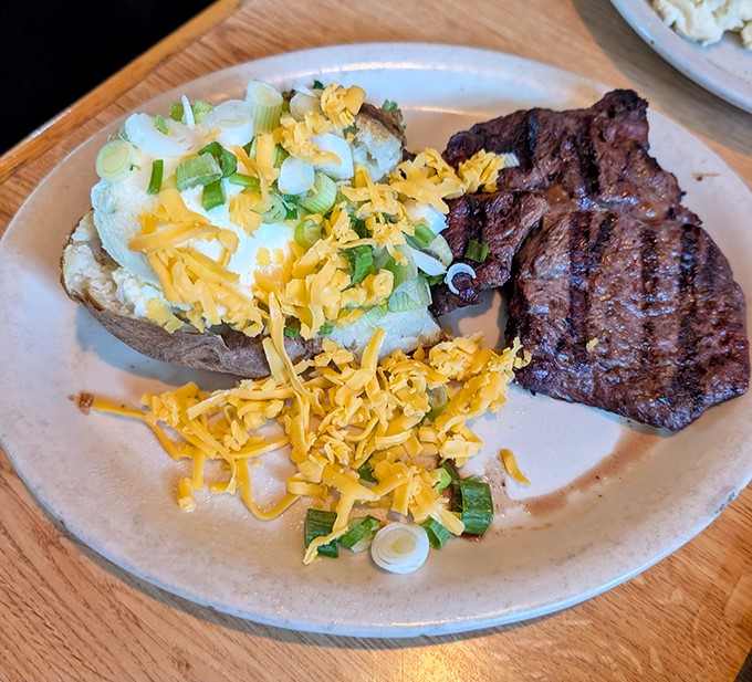 When steak meets baked potato, it's not just dinner – it's a relationship that was meant to be, complete with all the cheesy, oniony fixings.