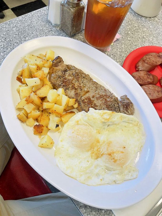 The holy trinity of breakfast: perfectly seasoned steak, golden home fries, and eggs that know exactly when to stop cooking.