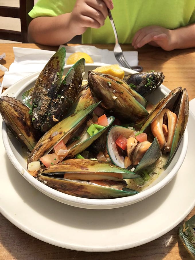 These mussels aren't just opened, they're having a full-blown conversation with herbs, tomatoes, and white wine.