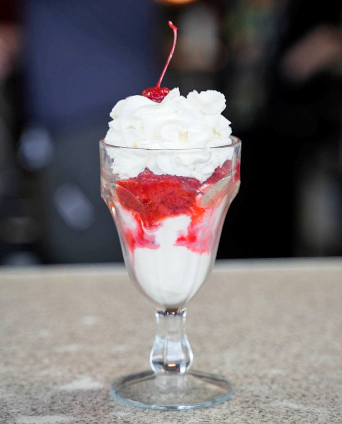 This strawberry sundae isn't trying to reinvent dessert—it's simply perfecting it with a harmony of vanilla ice cream, ruby-red sauce, and that essential cherry on top.