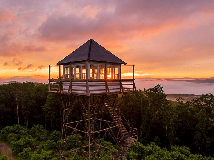 This fire tower offers sunset views that make you question why anyone pays resort prices when Mother Nature delivers this spectacle for free.