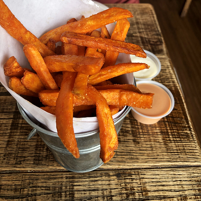 Sweet potato fries that could make a French chef weep. Perfectly crisp outside, cloud-soft inside, and served with dipping sauces that deserve their own fan club.