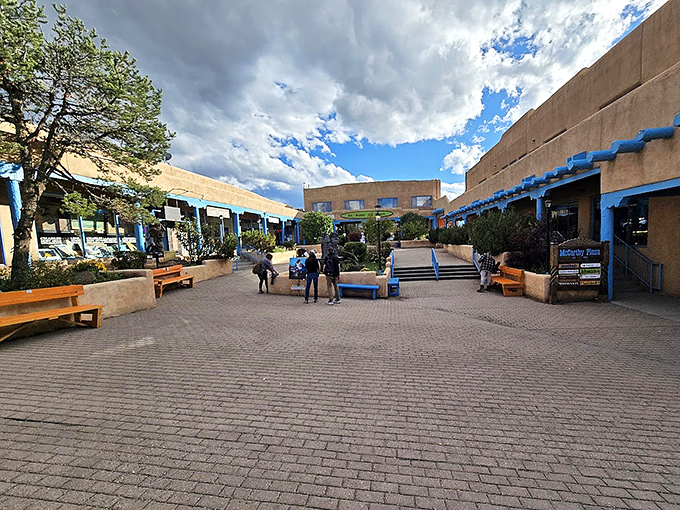 Taos Plaza's courtyards invite lingering conversations and spontaneous friendships. The blue trim against adobe walls? Pure New Mexican visual comfort food.