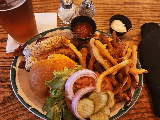 The Tavern Burger arrives like a delicious skyscraper of flavor, complete with crispy fries that deserve their own Ohio historical marker.