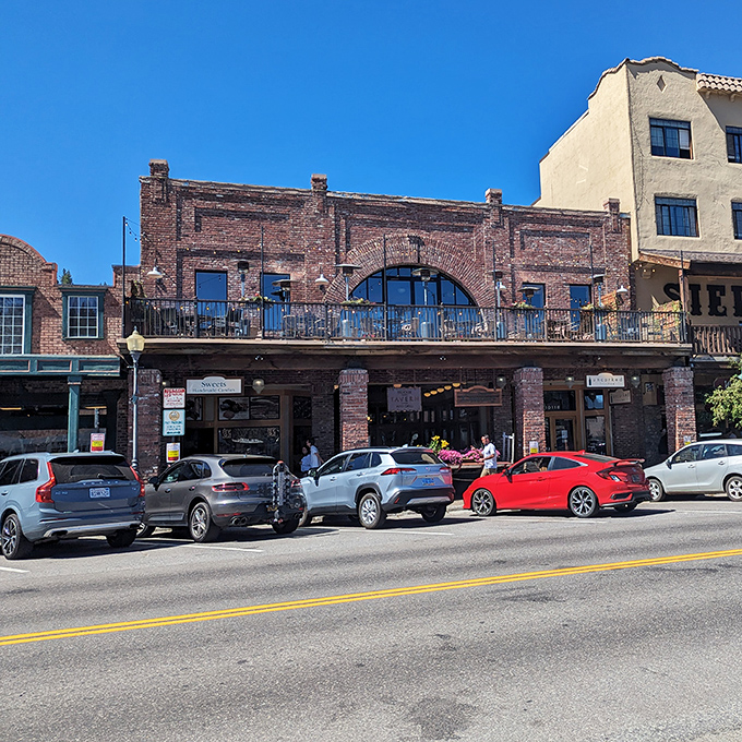 Historic brick buildings along Commercial Row house modern eateries and shops, their balconies perfect for people-watching with a local brew.