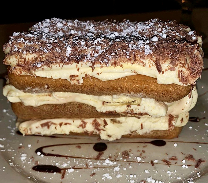 This isn't just tiramisu; it's architecture. Layers of coffee-soaked ladyfingers and mascarpone create the Pantheon of desserts, crowned with chocolate shavings.