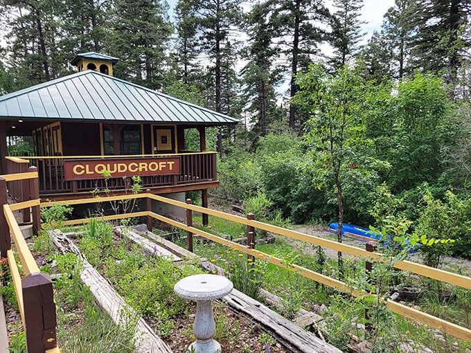 This charming gazebo proudly announces "CLOUDCROFT" like a friendly greeter, surrounded by a garden that seems to thrive on mountain magic and care.