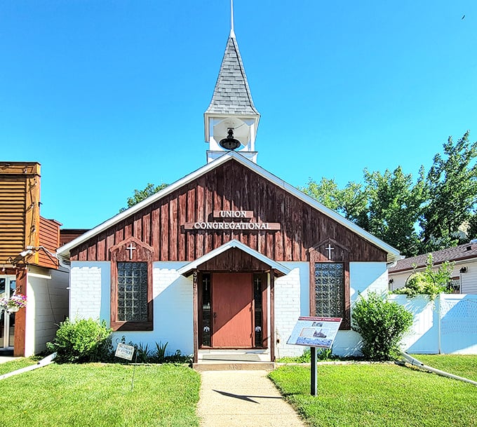 This charming white-and-brown church has likely witnessed more prairie weddings and baptisms than a Hallmark movie marathon.