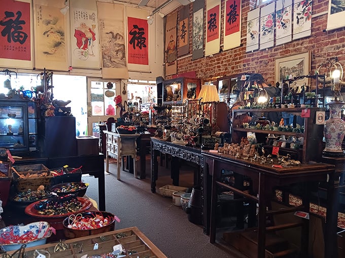 Chinese scrolls dance above antique furniture, creating a visual symphony where East meets West and every piece whispers, "Take me home to impress your dinner guests."