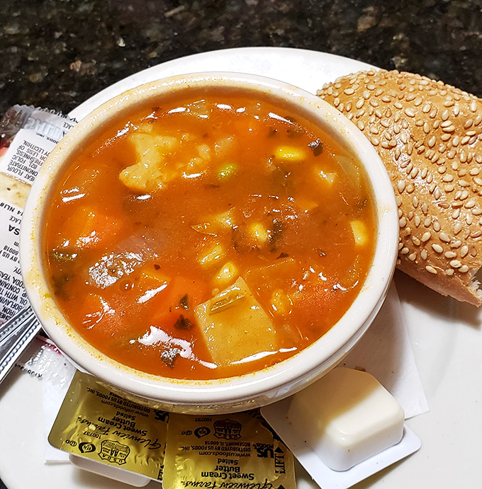 A steaming bowl of vegetable soup that could make even your grandmother nod in approval. Comfort in liquid form, served with a side of nostalgia.