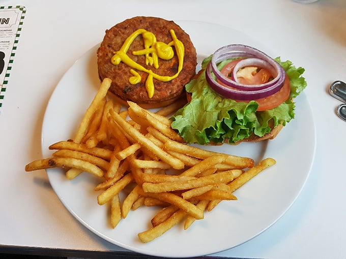 This isn't just a veggie burger&mdash;it's a statement piece with mustard calligraphy, crisp lettuce, and fries that stand at attention like golden soldiers.