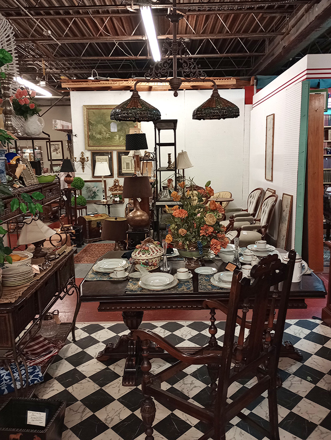 A perfectly set antique dining tableau invites imaginary guests from the past, complete with Tiffany-style lamps hovering above like illuminated jellyfish.