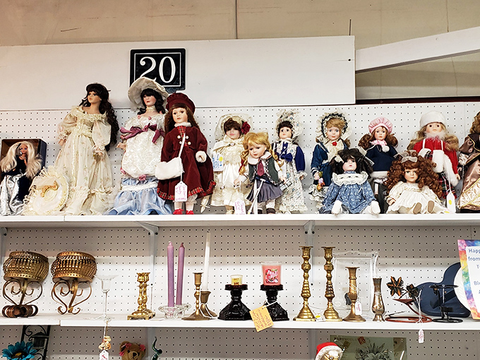 The doll collection watches with painted eyes and permanent smiles, like a tiny audience from another era judging your decorating choices.