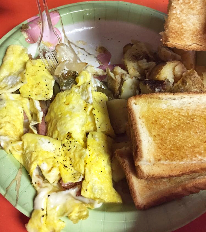 Scrambled eggs mingling with ham and potatoes on a mint-green plate&mdash;the breakfast equivalent of a perfect jazz trio, each element complementing the others.