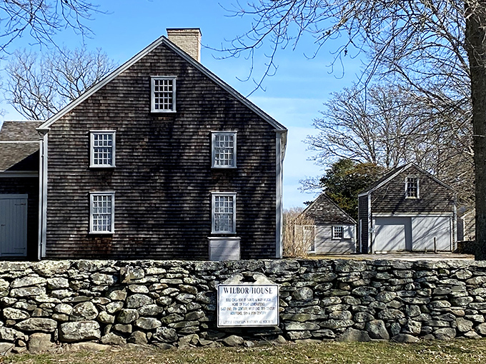 The weathered cedar shingles of Wilbor House tell stories dating back to the 1600s. Behind that stone wall sits one of Rhode Island's most authentic colonial treasures.