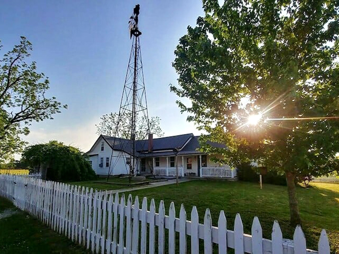 A classic white farmhouse with picket fence and windmill&mdash;Norman Rockwell couldn't have painted a more quintessential slice of rural America.