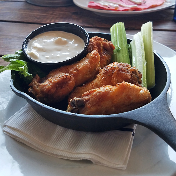 Wings that could make a vegetarian question their life choices, served with celery that's really just there for moral support.