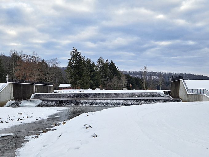 Winter transforms the spillway into a monochromatic masterpiece. Snow and ice create a landscape that would make Ansel Adams reach for his camera.