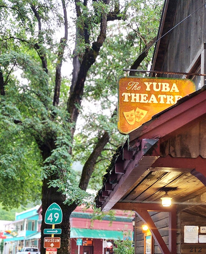 The Yuba Theatre sign hangs like a golden promise of entertainment, a cultural touchstone where Highway 49 meets mountain town creativity.
