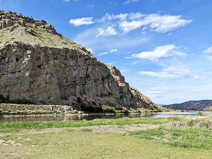 Limestone cliffs stand guard over the river like ancient sentinels, watching over centuries of water flowing toward distant destinations.