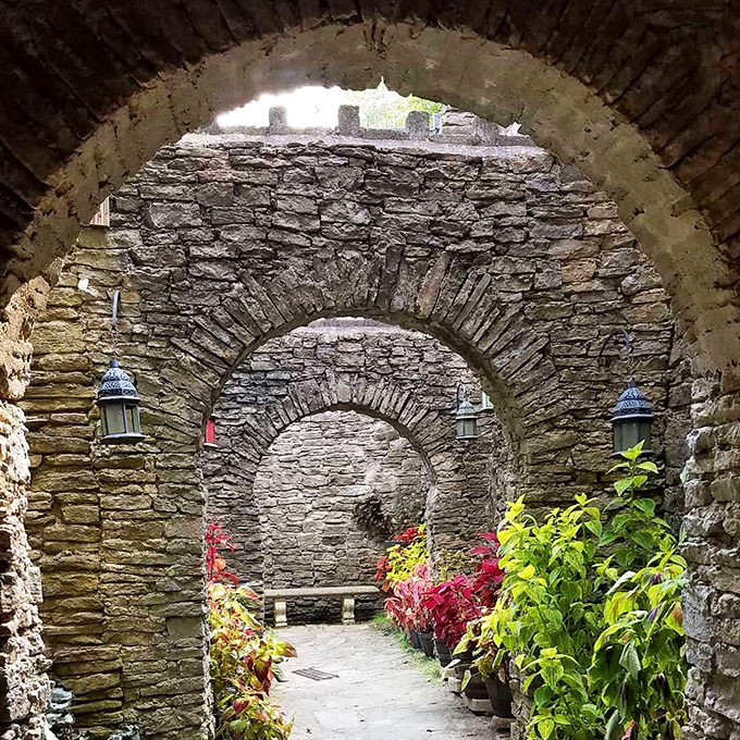Stone archways frame a garden passage that feels like a portal to another time. No DeLorean required for this time travel.