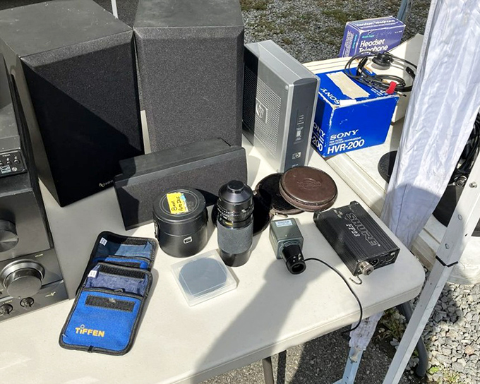 A photographer's dream table: camera lenses, filters, and equipment that once documented life's moments now await their second act.