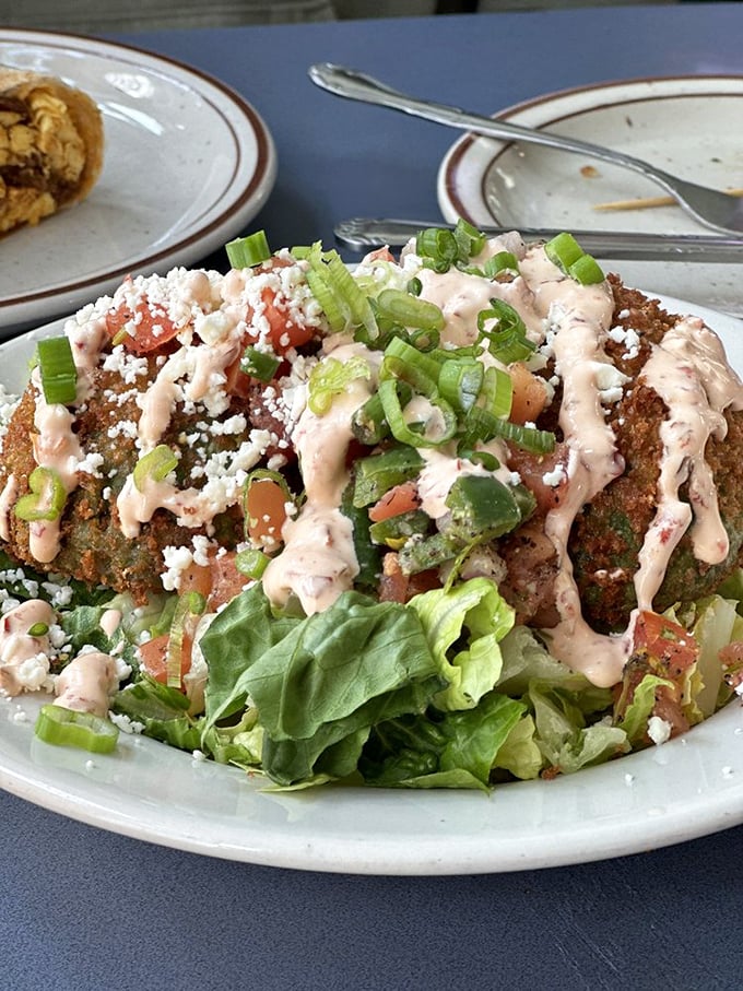 Southwest Diner's black bean cakes arrive like edible art&mdash;crispy exterior giving way to a flavorful interior, topped with fresh pico, crema, and a confetti of green onions.