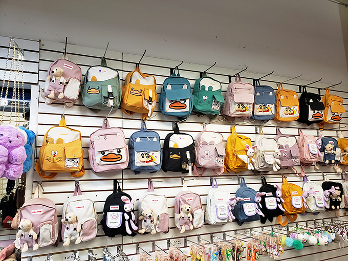Backpacks featuring cartoon characters and animals create a wall of personality where school supplies become fashion statements.